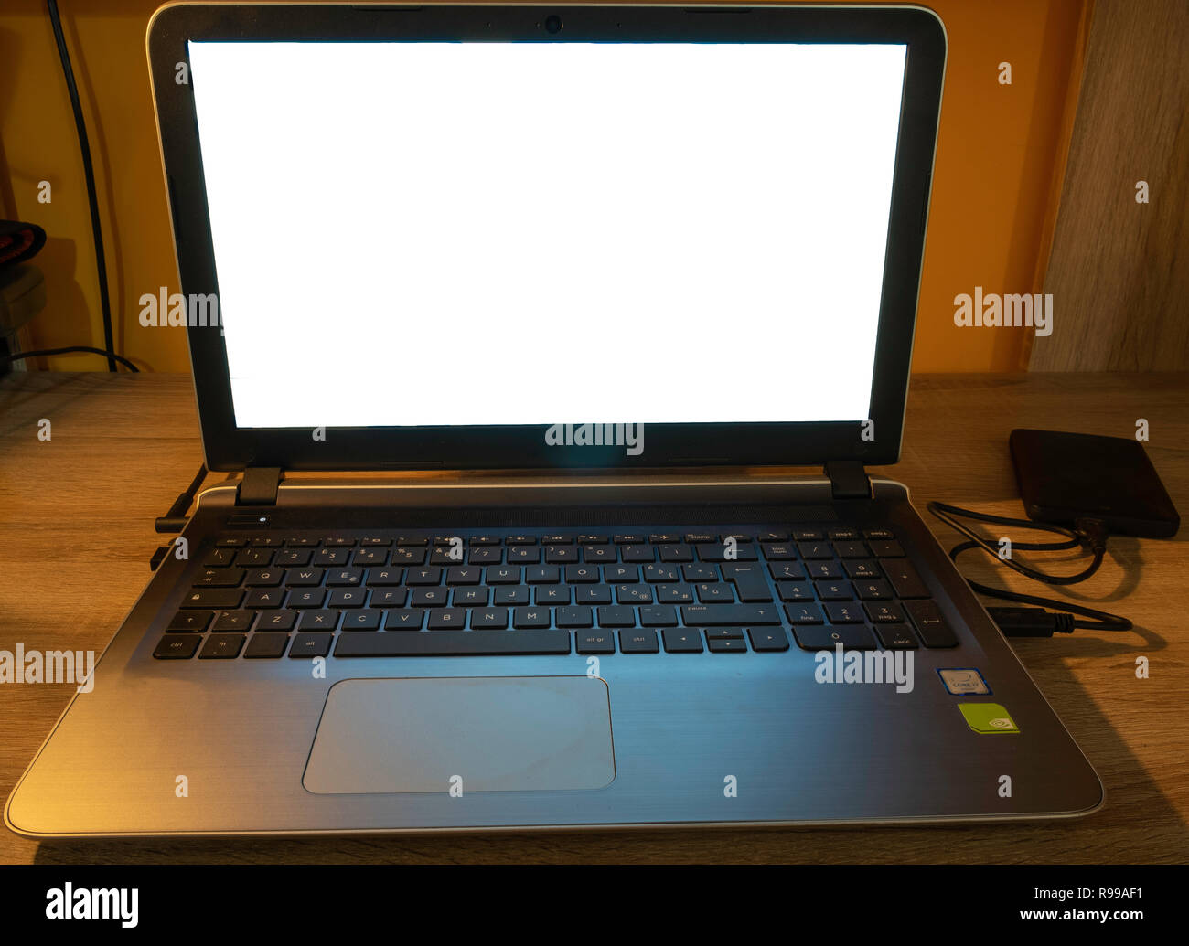 Front view of laptop with blank white screen standing on the white ...