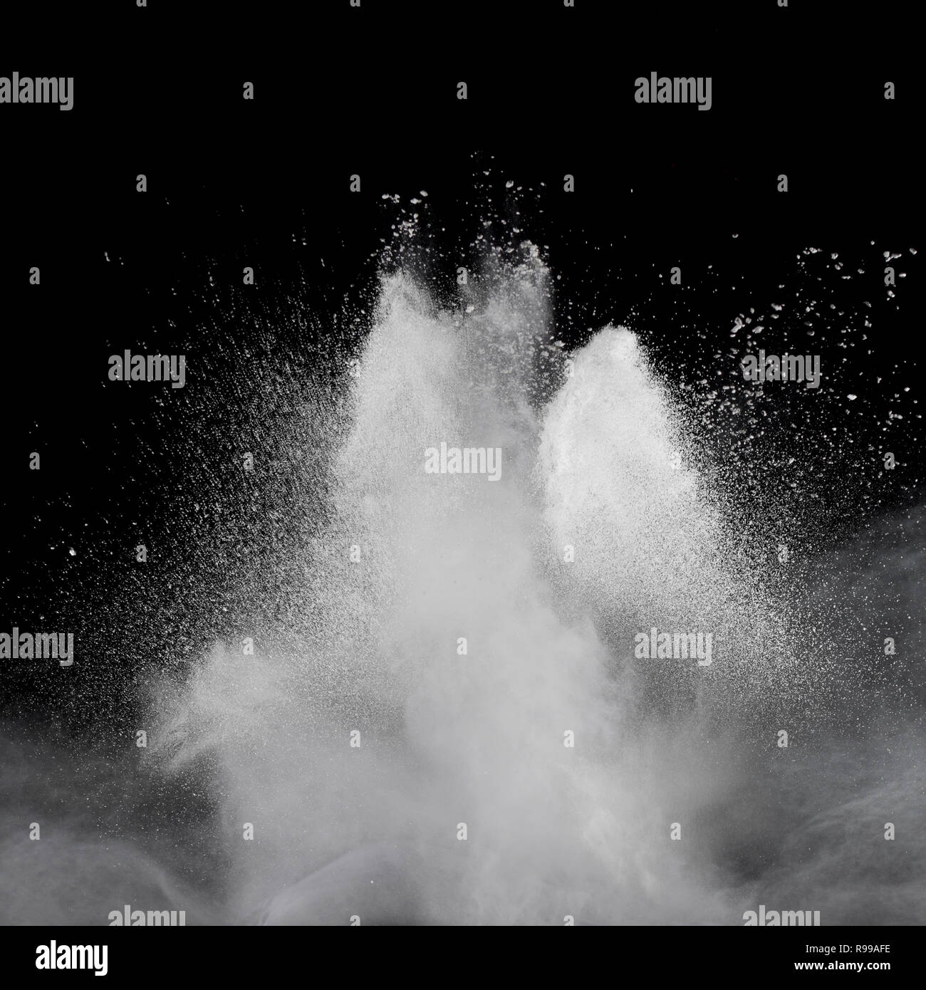 Freeze motion of white dust particles on black background. White powder ...