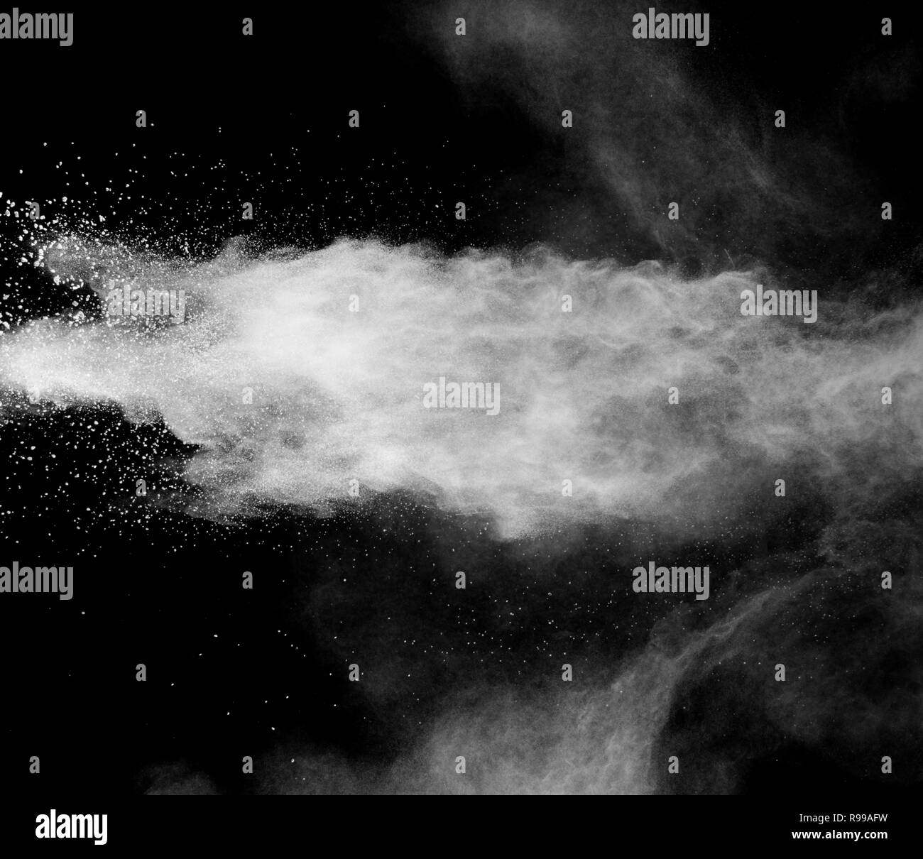 Freeze motion of white dust particles on black background. White powder ...