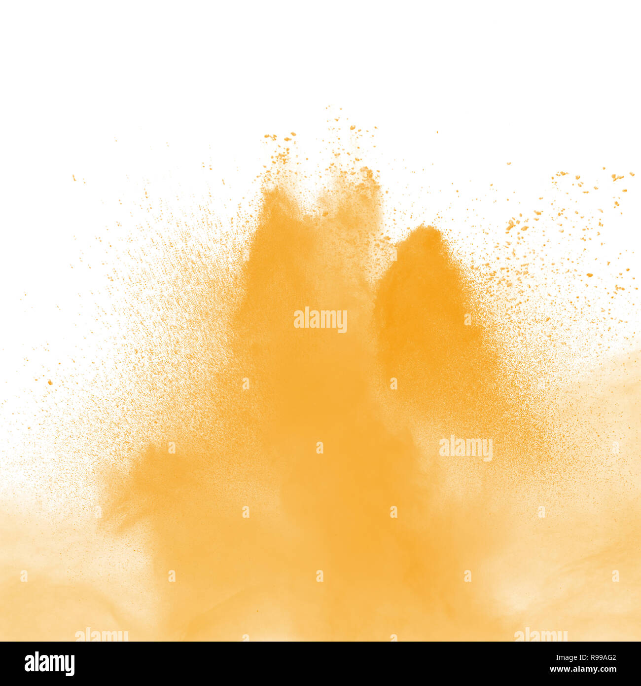 Abstract yellow dust explosion on white background. Freeze motion of ...