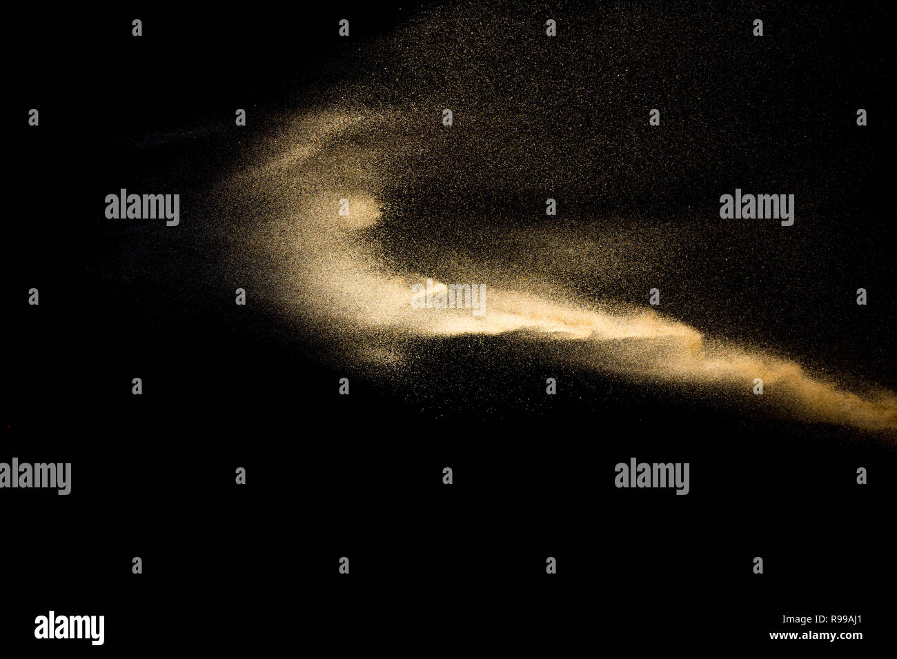 Dry river sand explosion. Golden color sand splash against black ...