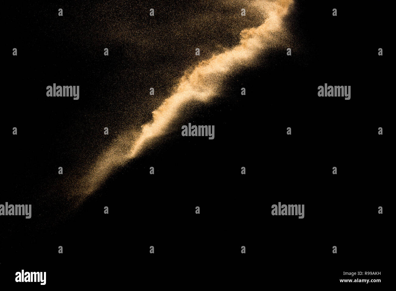 Dry river sand explosion. Golden color sand splash against black ...