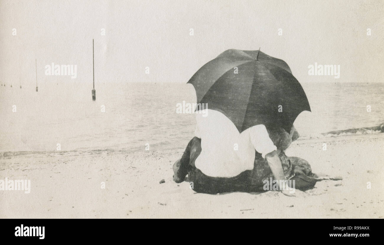 Antique 1908 photograph, Victorian couple under a sun umbrella on the ...