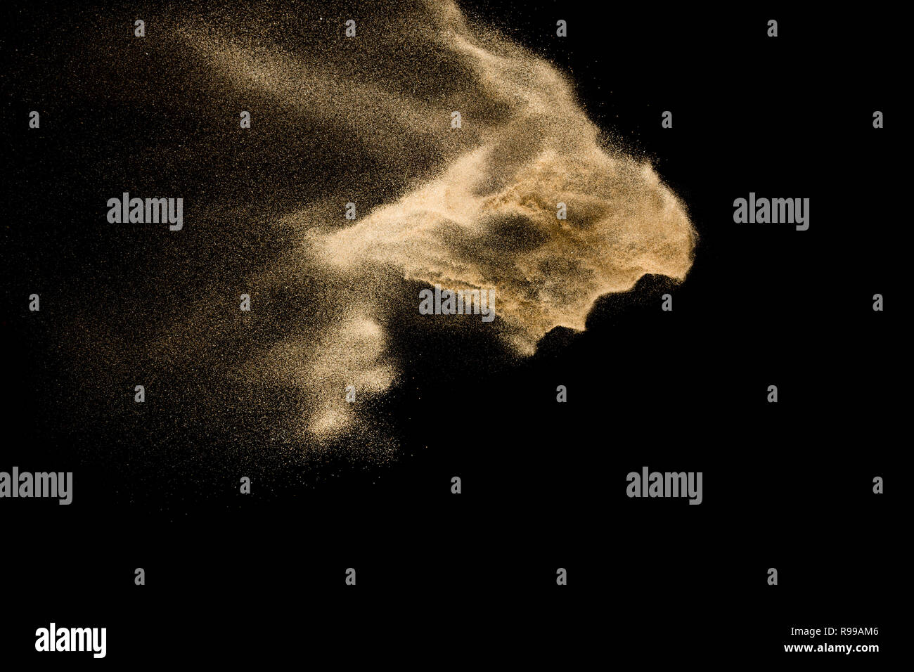 Dry river sand explosion. Golden color sand splash against black ...