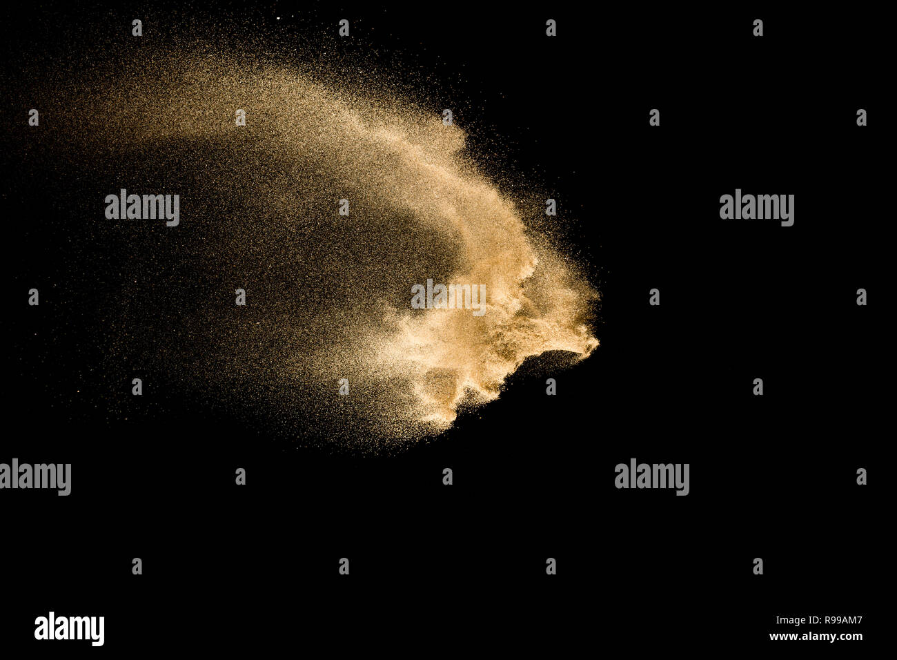 Dry river sand explosion. Golden color sand splash against black ...