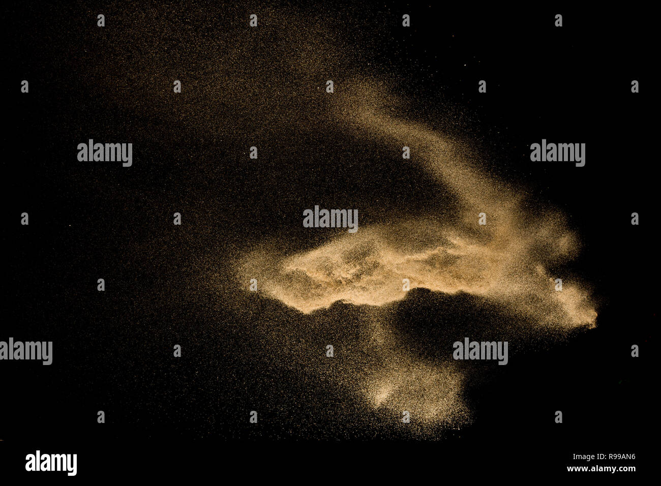 Dry river sand explosion. Golden color sand splash against black ...