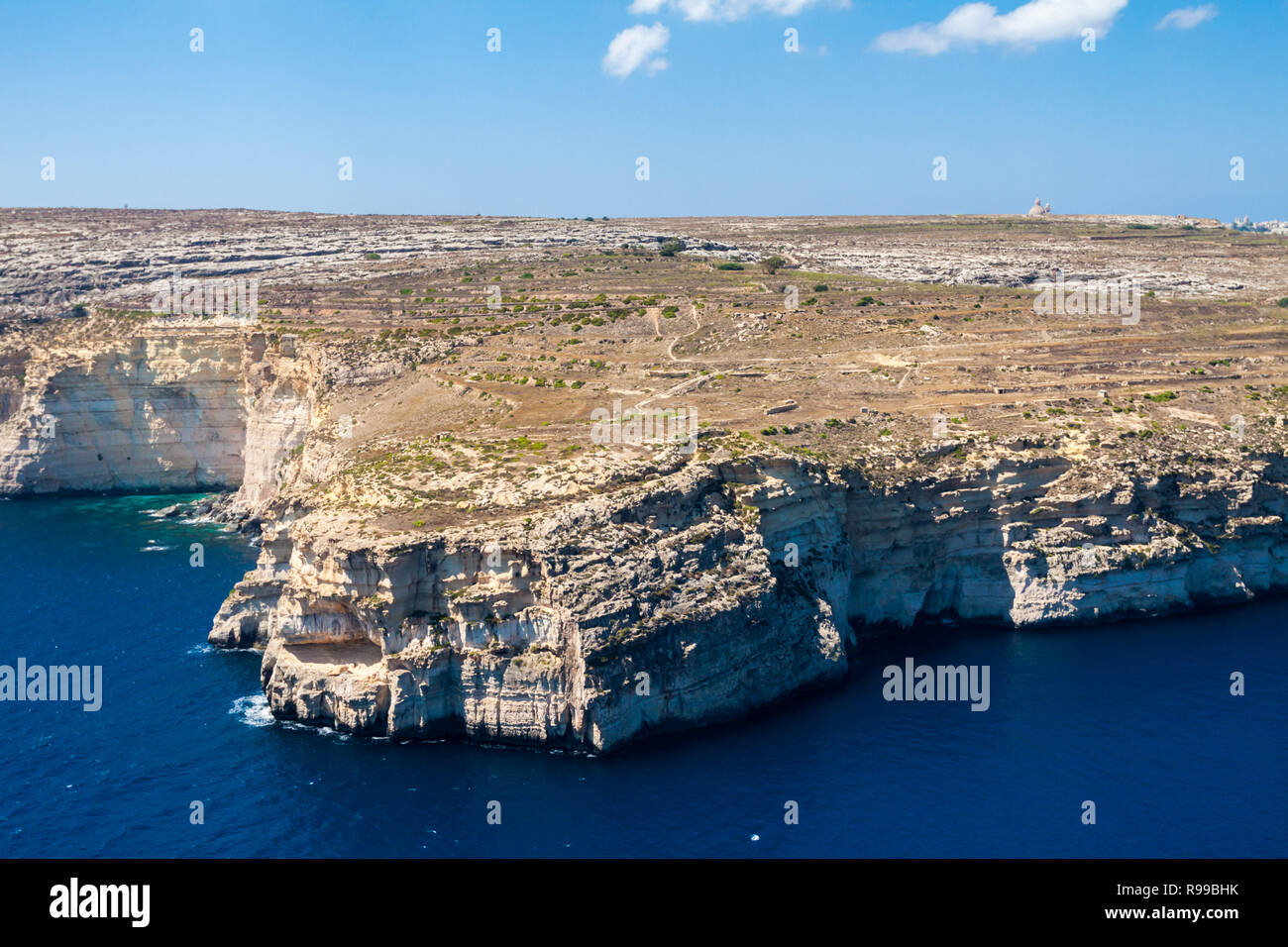 Cliffs and blue lagoons of Gozo island seen from above. Aerial view of ...