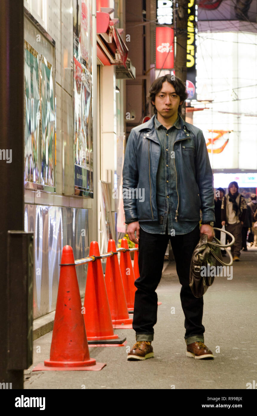 Asian male model poses for pictures in the street Stock Photo - Alamy