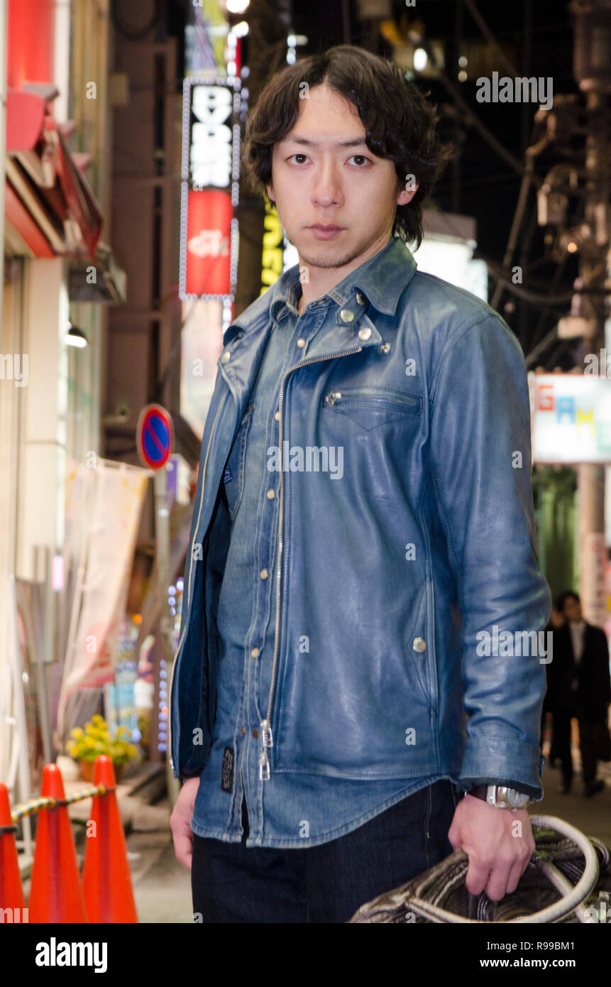 Asian male model poses for pictures in the street Stock Photo - Alamy