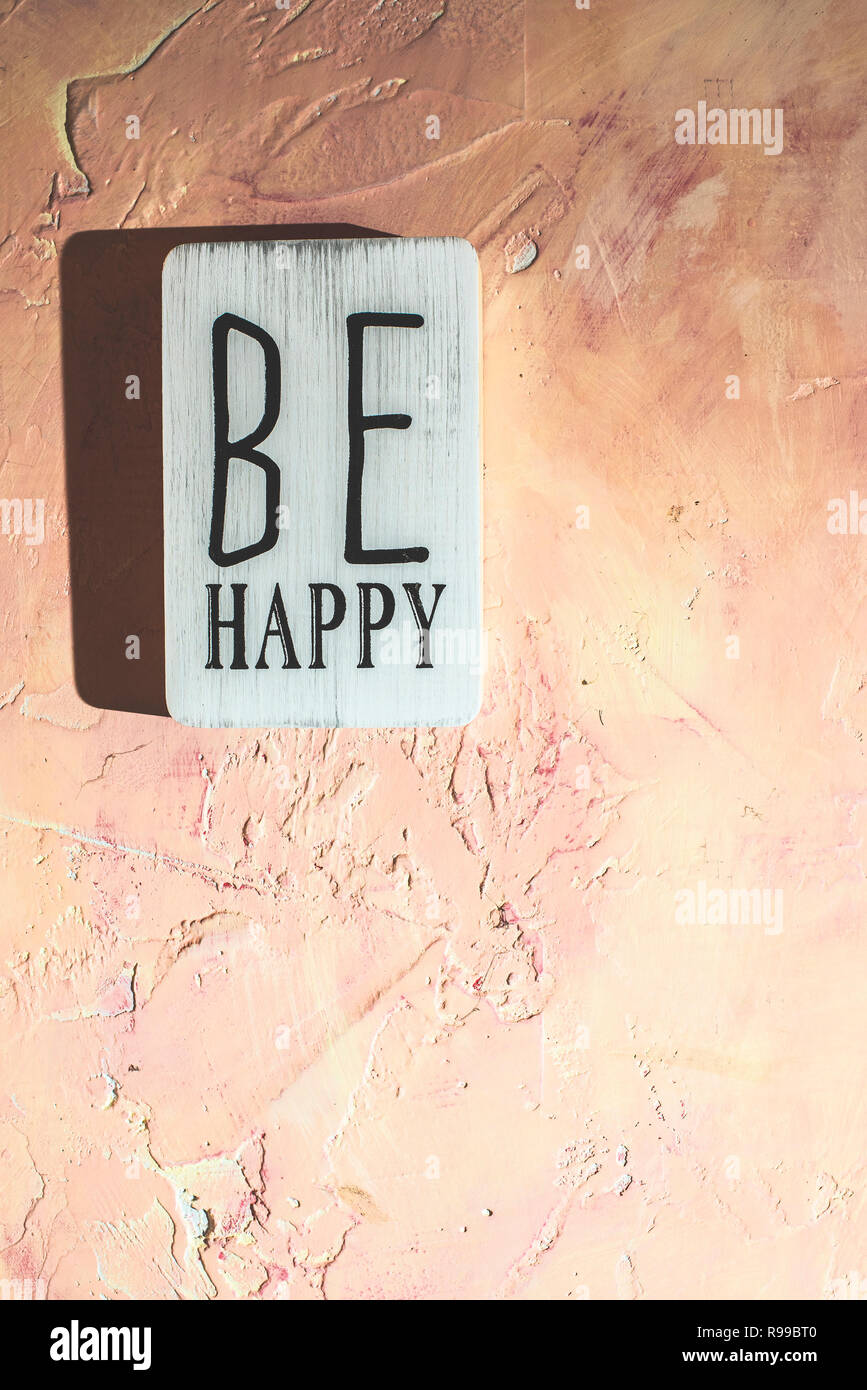 Be happy words on pink wall in a room. Daily light from window ...