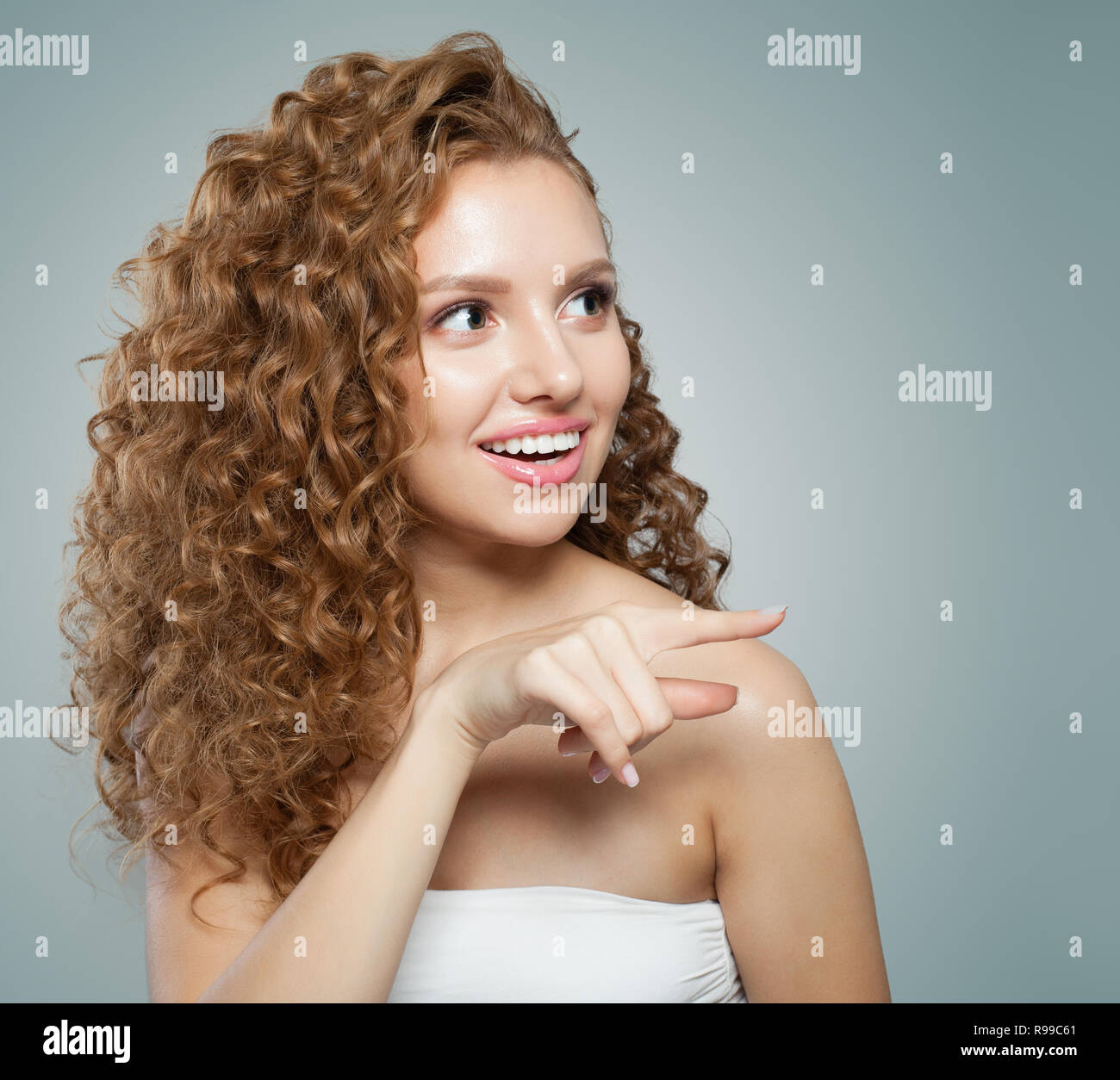 Cheerful young woman pointing. Happy girl student with positive emotion ...