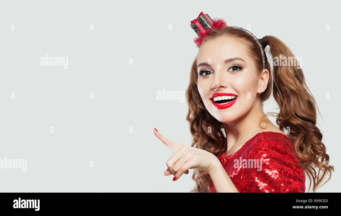 Funny woman smiling and pointing finger on white background Stock Photo ...
