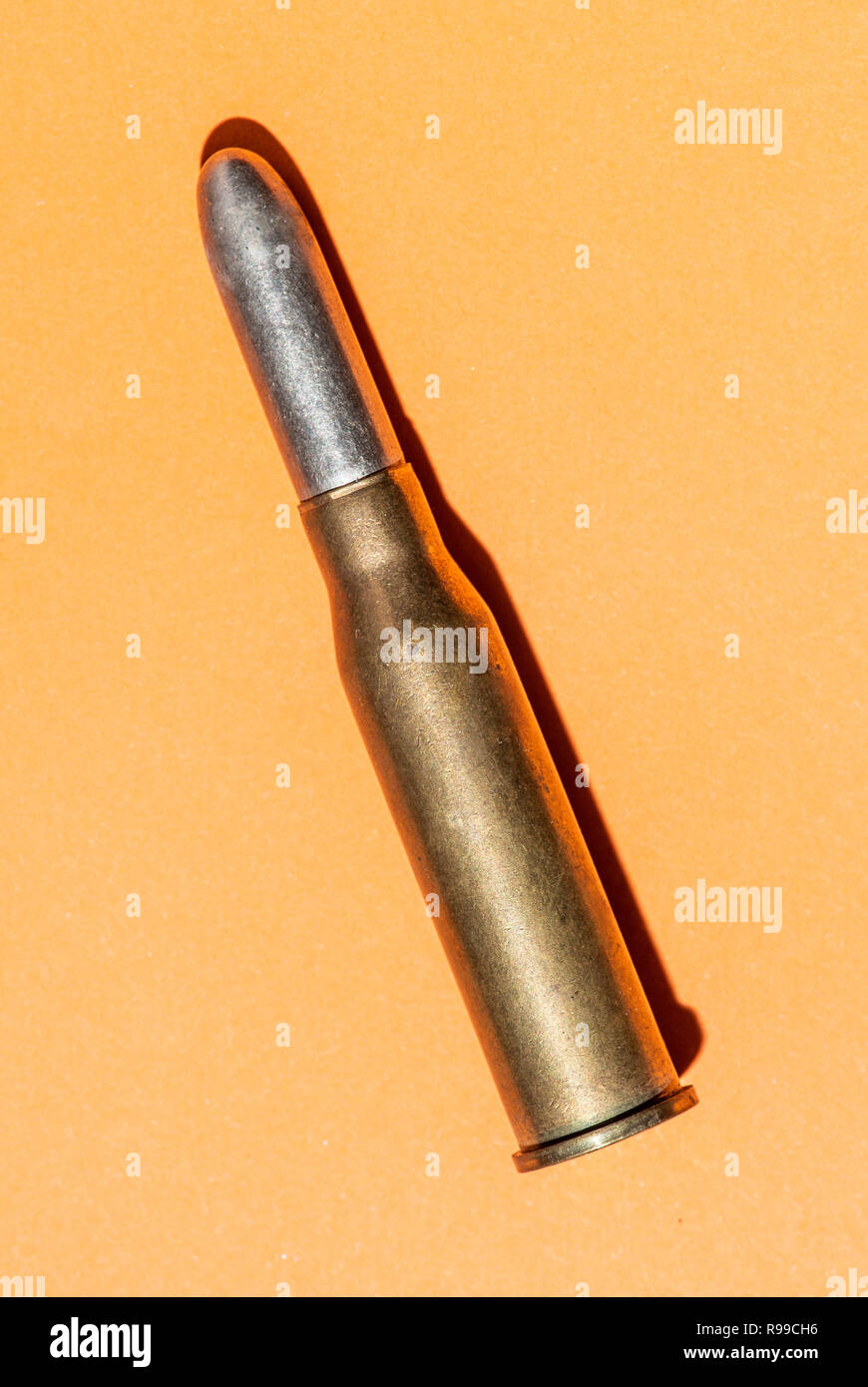 One weapon cartridge on clean background. Single isolated bullet on ...