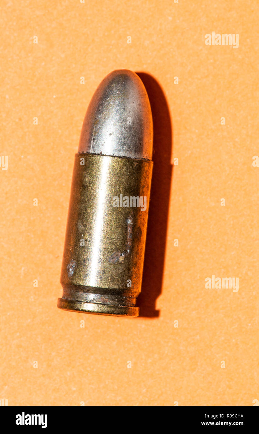One weapon cartridge on clean background. Single isolated bullet on ...