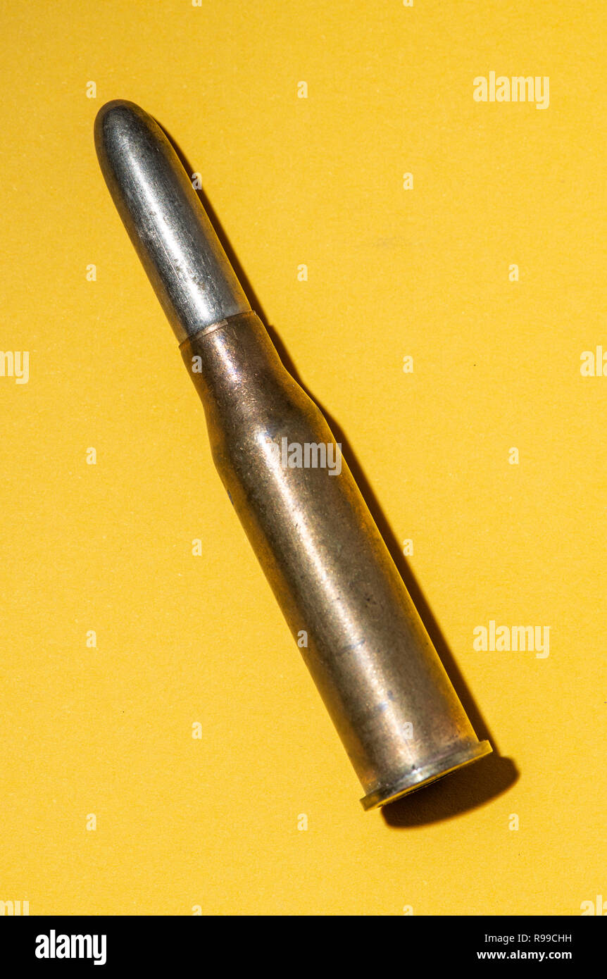 One weapon ammunition on clean background. Single isolated bullet on ...