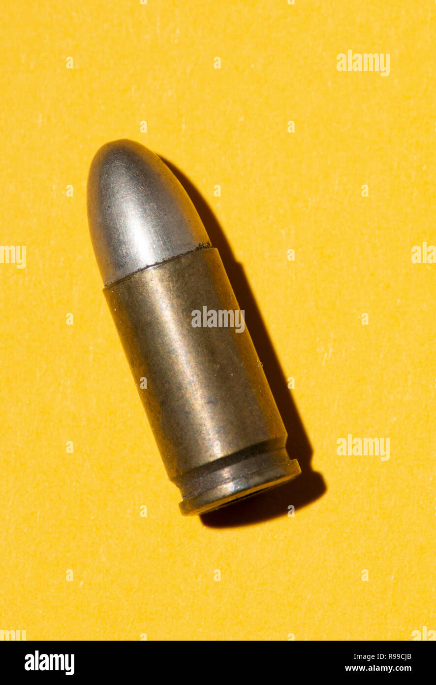 One weapon ammunition on clean background. Single isolated bullet on ...