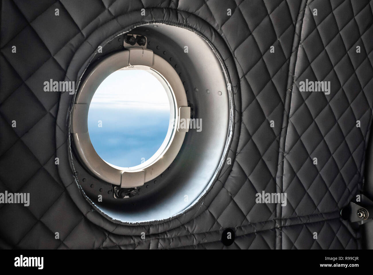 Interior of military plane. View through the window during the fly. War ...