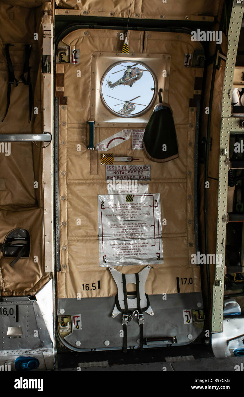 Interior of military plane. Opened door during the fly. Military ...