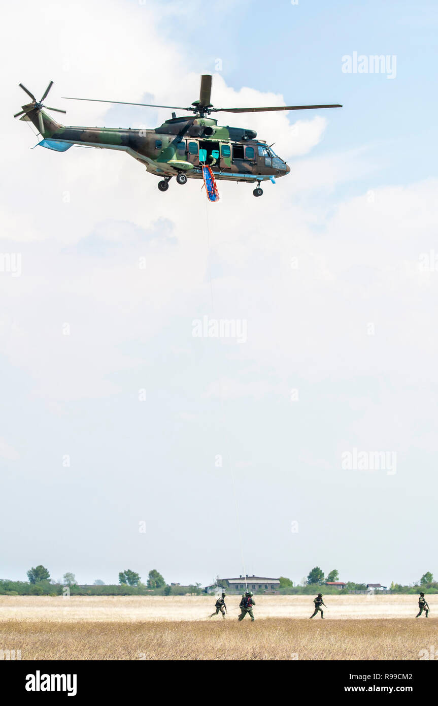 Soldiers on a rescue military operation with helicopter. War and ...