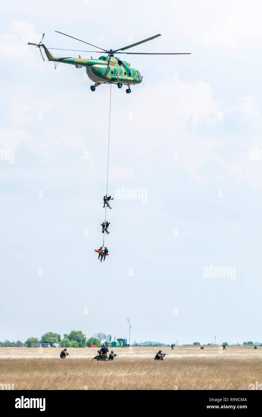 Soldiers go down a rope from military helicopter. Military special ...