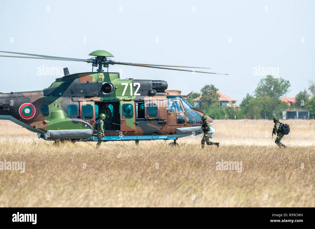 Soldiers on a rescue military operation with helicopter. War and ...