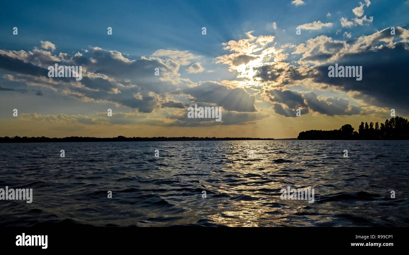 Warm summer sunset over the river Danube on the background of a blue ...