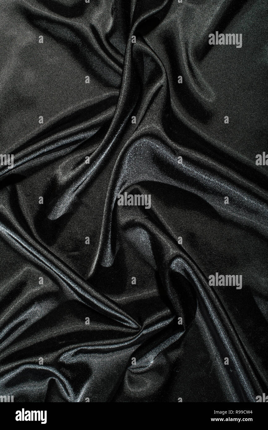 Background of black satin fabric. Shiny silk backdrop Stock Photo - Alamy