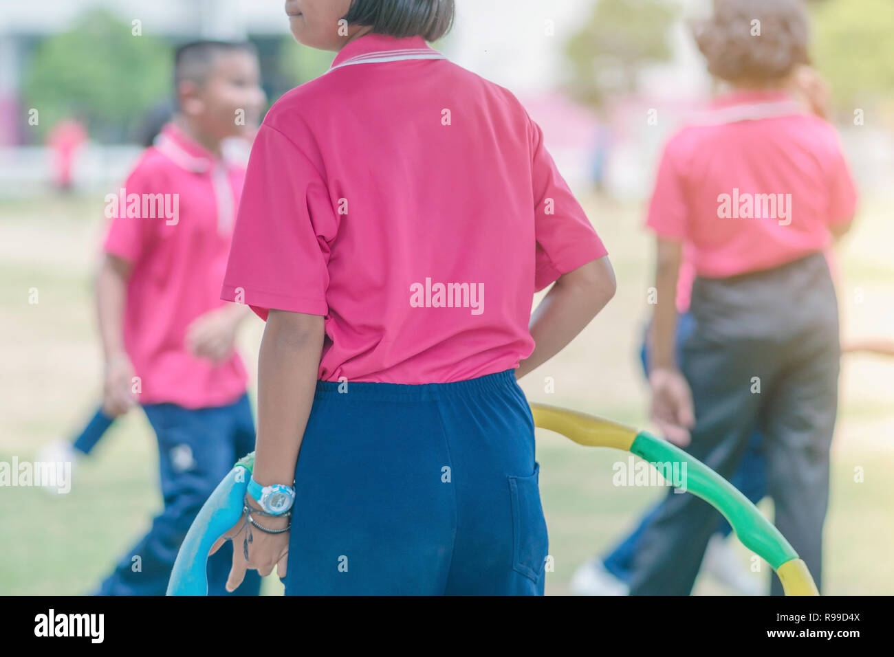 Female students doing exercise with a hula-hoop for a good healthy at ...