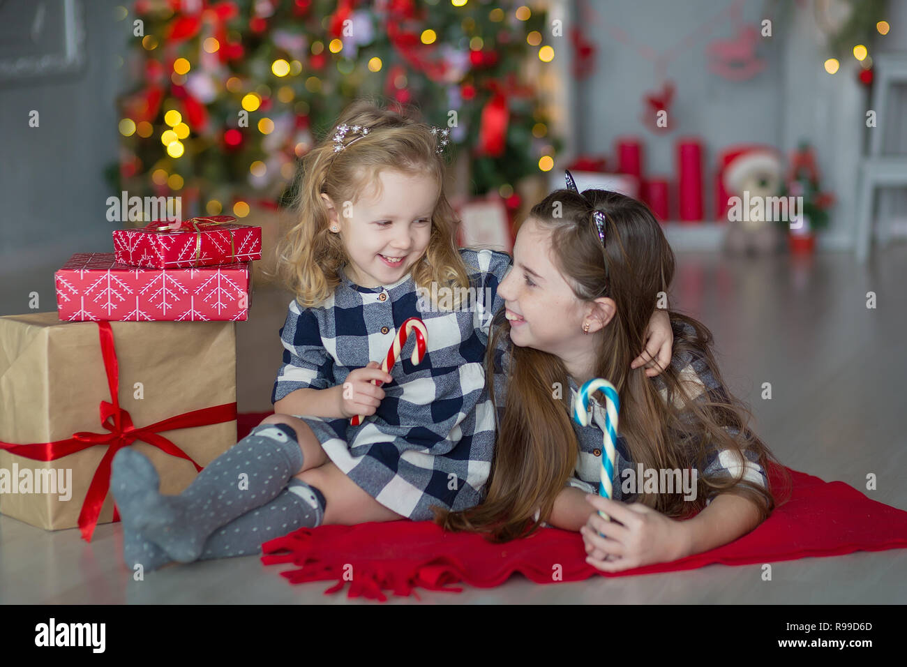 Two cute awesome girls sisters celebrating New Year Christmas close to ...