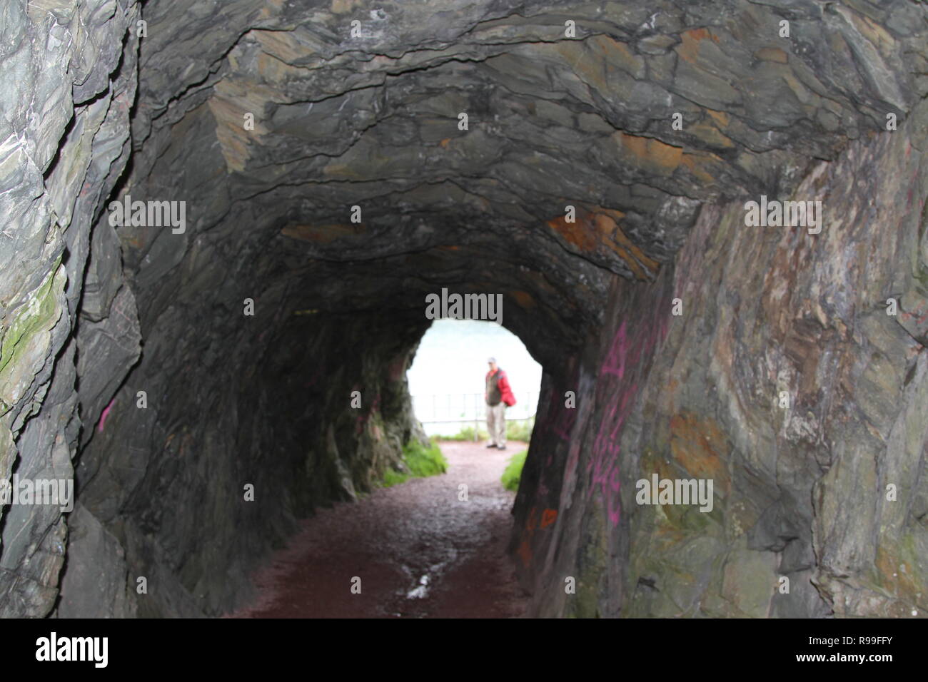 Old pedestrian tunnel under a rock Stock Photo - Alamy