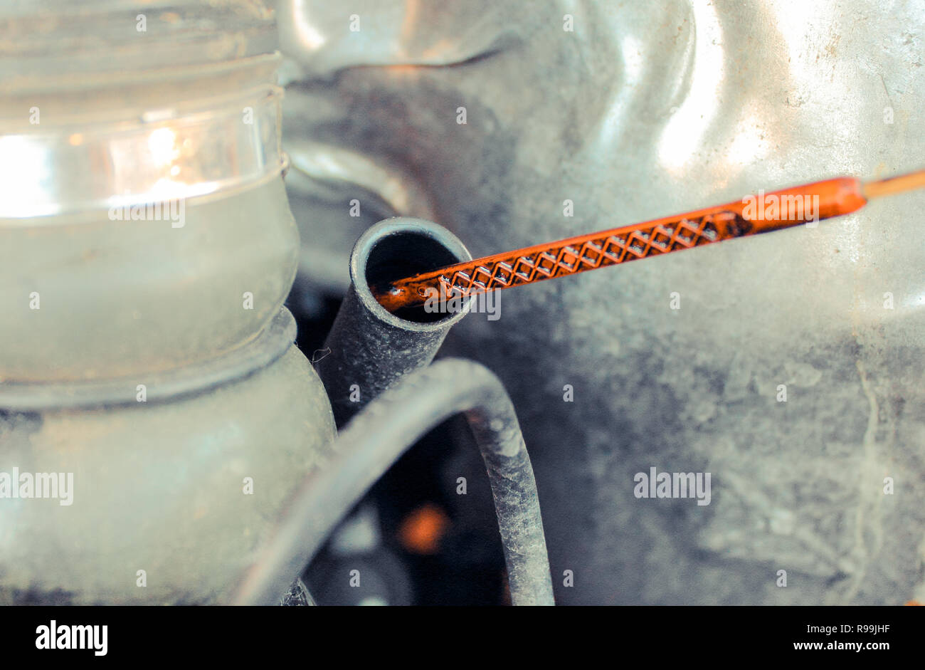 Closeup of oil dipstick in car engine, concept of checking oil level ...