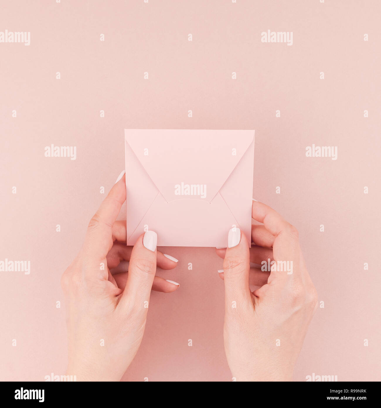 Creative image of woman hand holding small love letter with copy space ...