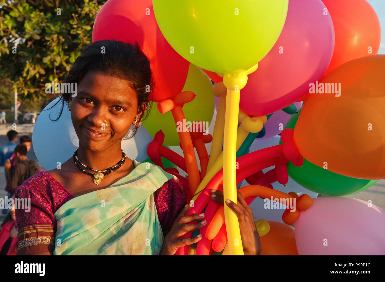 A girl selling balloons to visitors and their children at Marine Drive ...