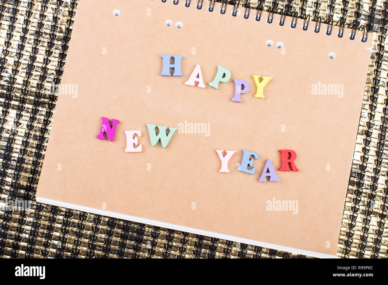Notepad of kraft paper on a golden background with the inscription ...