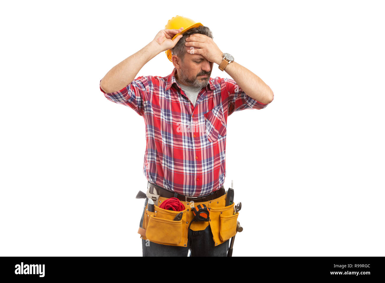 Construction worker taking off yellow safety hardhat and touching ...