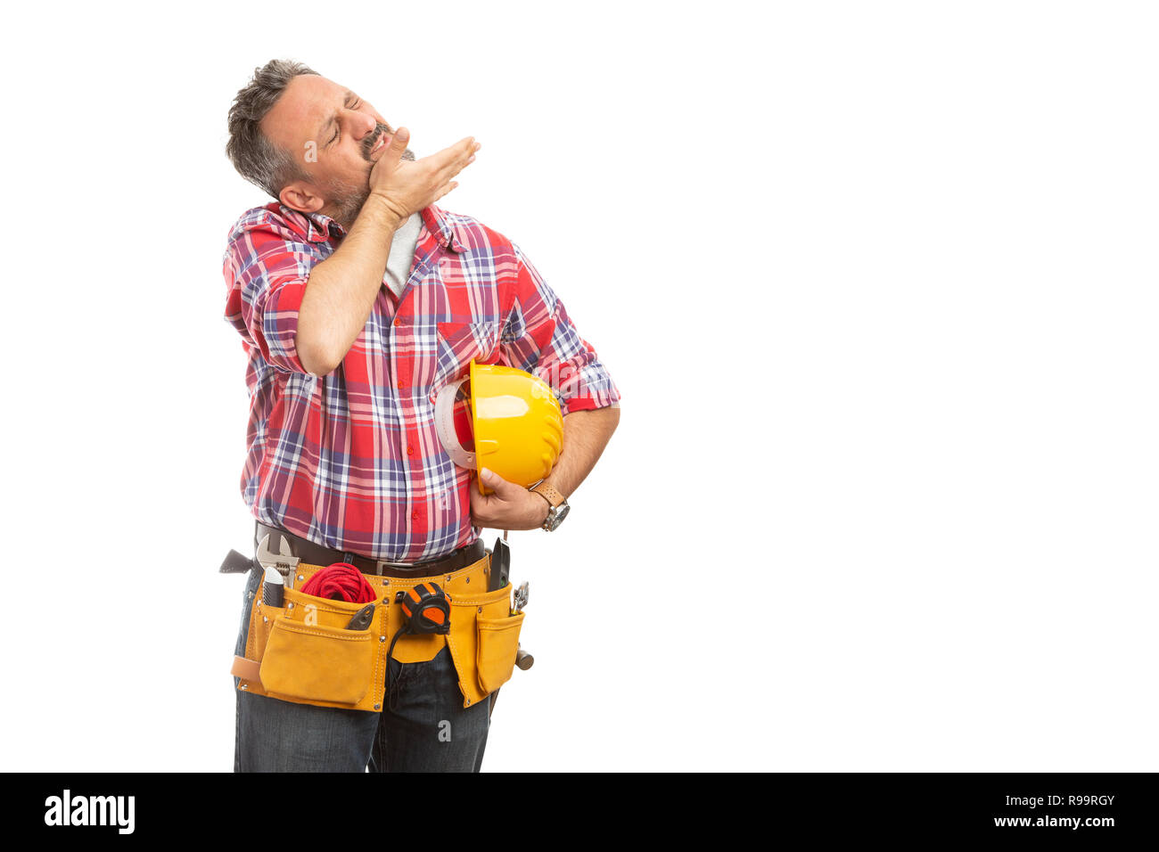 Builder preparing for hard work and physical effort as stretching neck ...