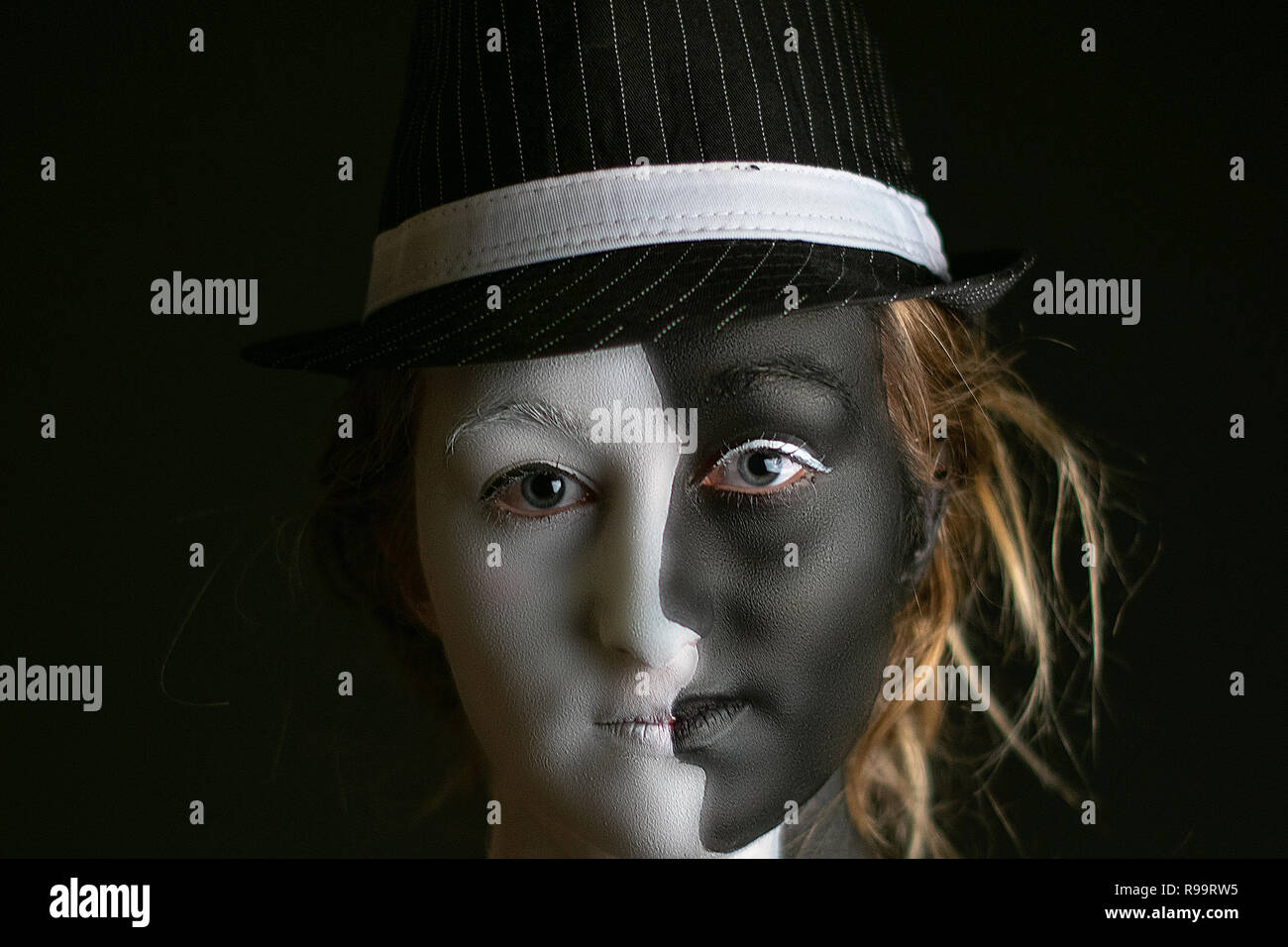 Yin / Yang - Studio portrait of a face painted young woman Stock Photo ...