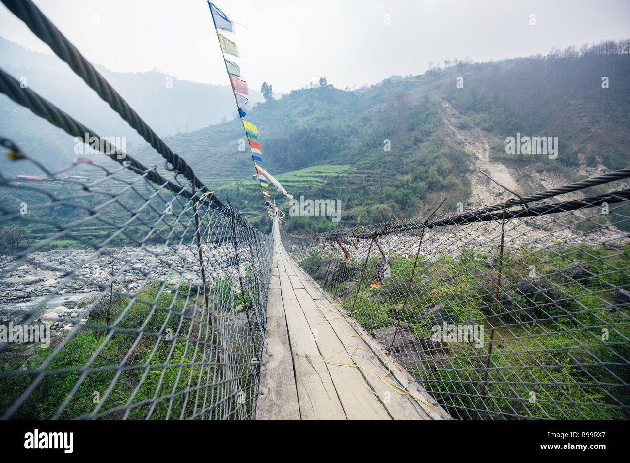 Suspension bridge in Himalayas Stock Photo - Alamy