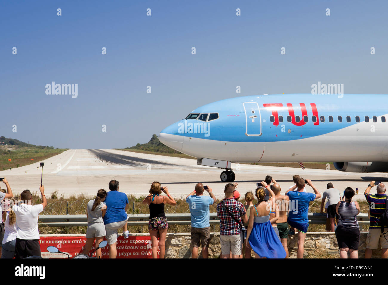 SKIATHOS, GREECE - AUGUST 18, 2017. Edge of the runway where tourists ...