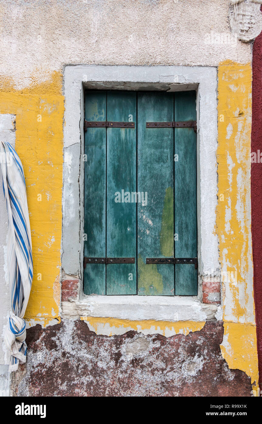 faded paintwork and shutters of painted houses in Burano Venice Italy ...