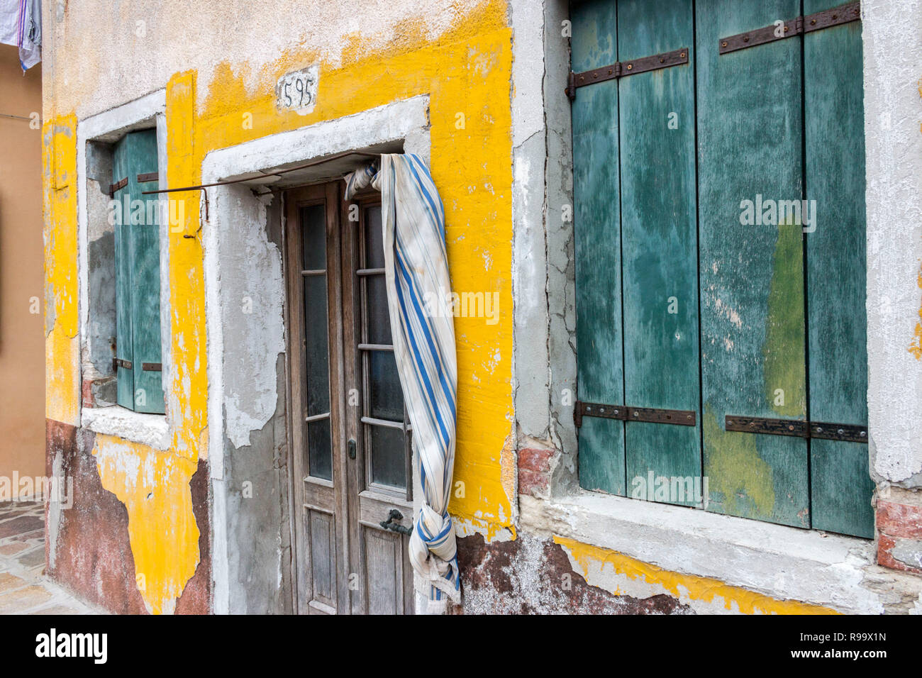 faded paintwork and shutters of painted houses in Burano Venice Italy ...