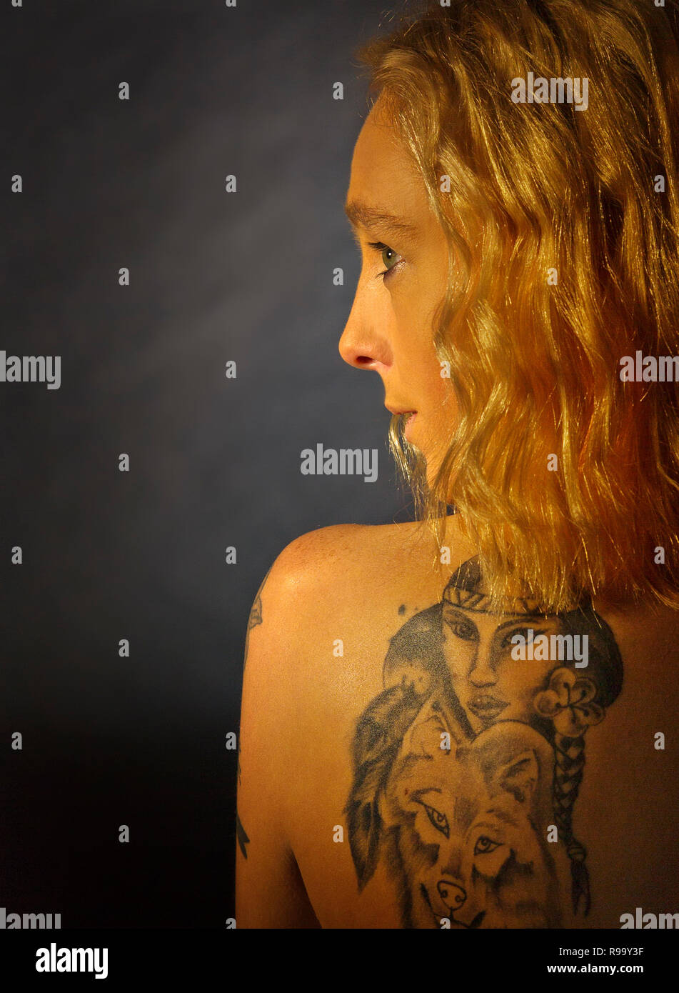 Blond girl tattoo hi-res stock photography and images - Alamy