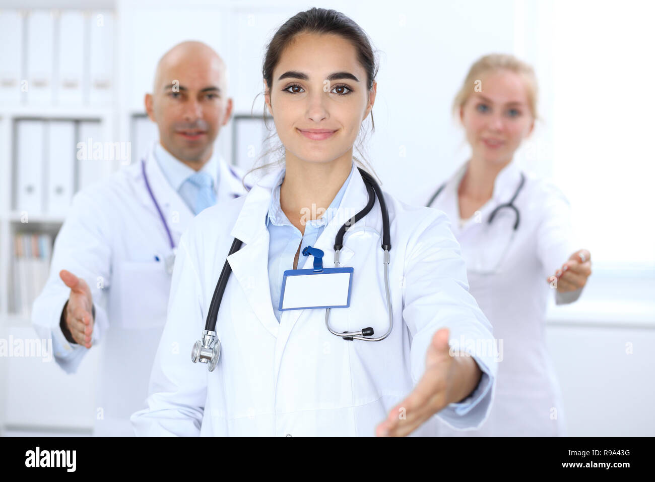 Happy doctor woman with medical staff at the hospital. Helping hand ...