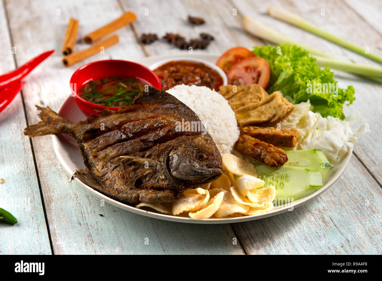 traditional malay indonesian fried pomfret fish rice Stock Photo - Alamy