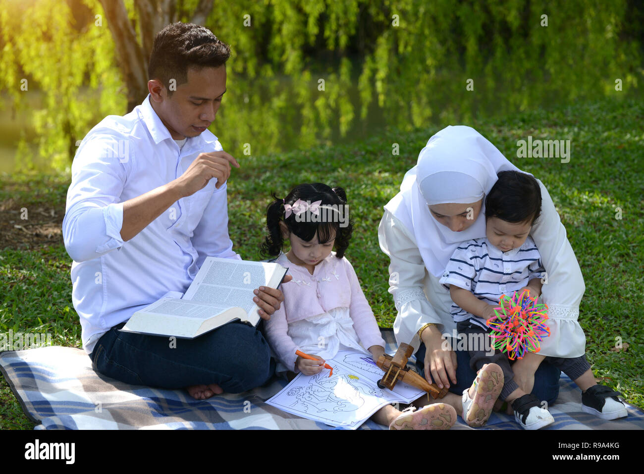 malay family reading outdoor Stock Photo - Alamy