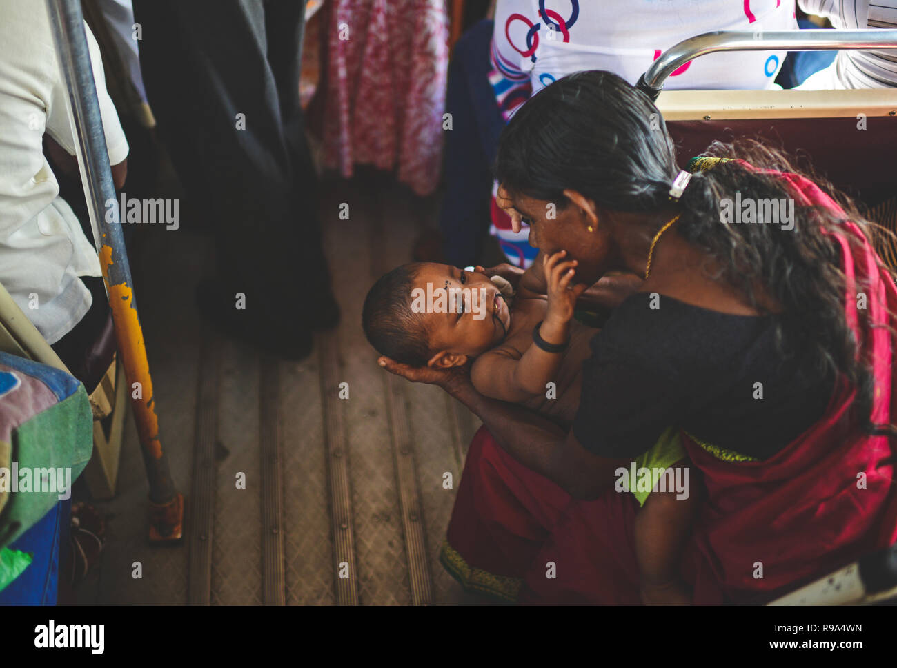 Mother calms a baby inside a public bus, Sri Lanka Stock Photo - Alamy