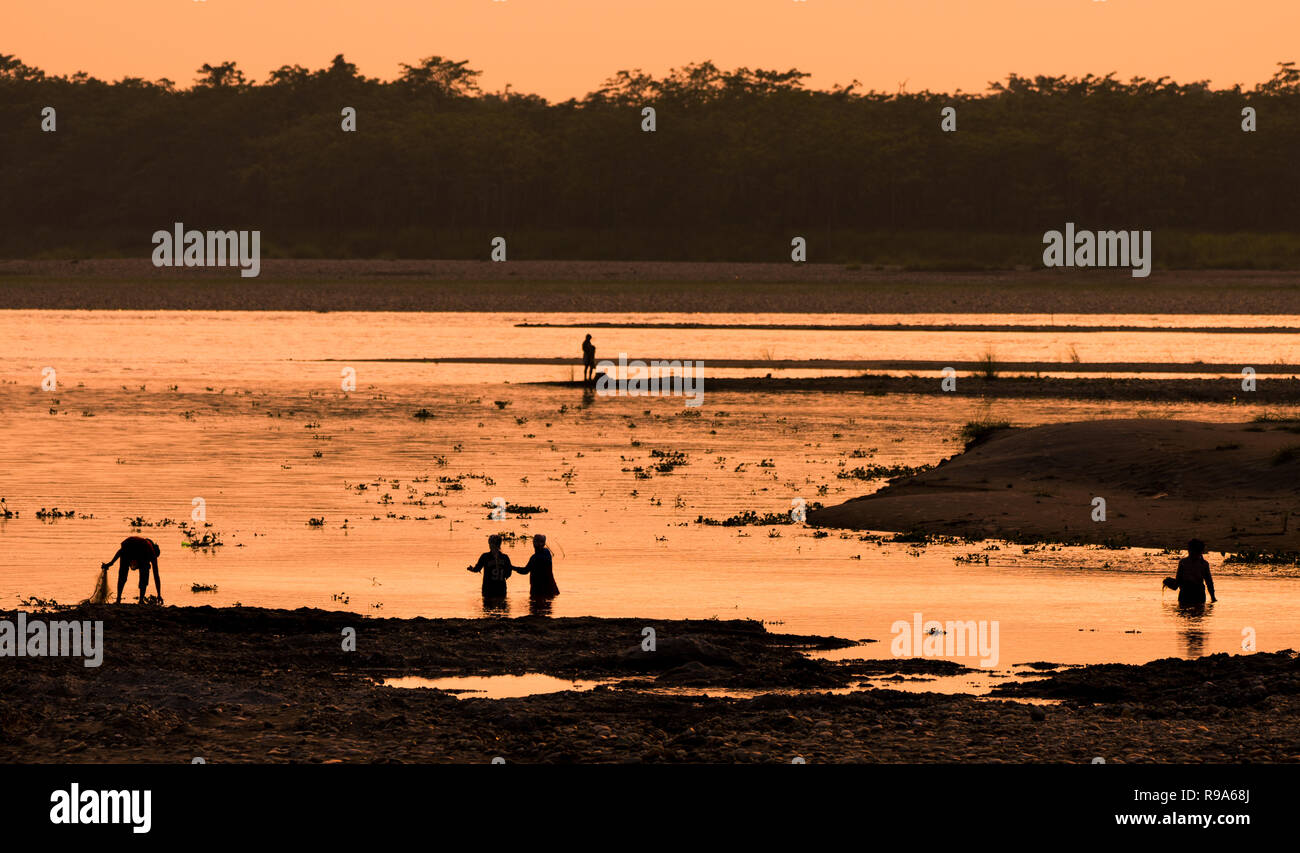 Asian Women fishing in the river. silhouette at sunset. Village life in ...