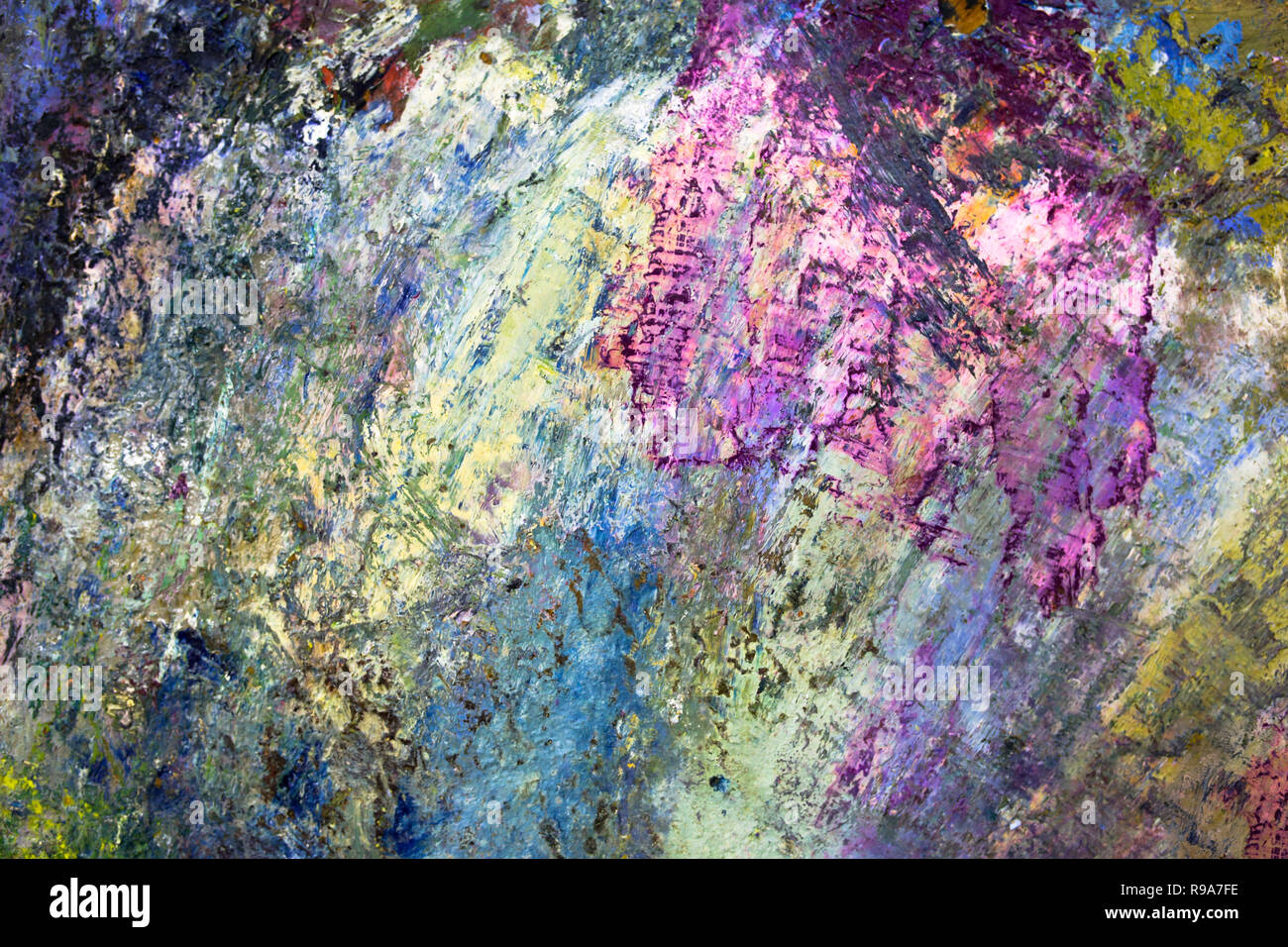multi-colored strokes of oil paint on the artist's palette. the texture ...