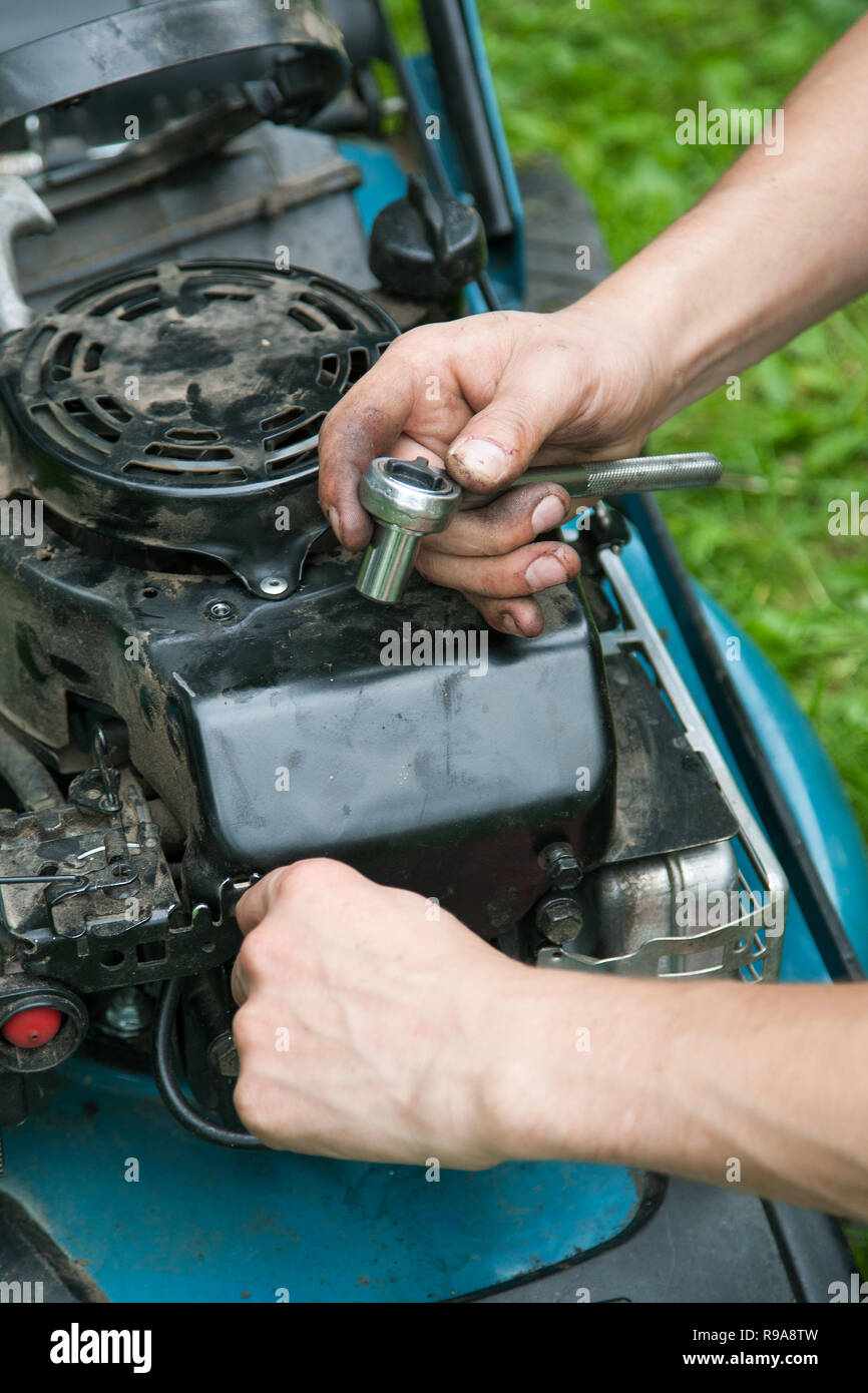 men's hands and gasoline engine repair close-up Stock Photo - Alamy