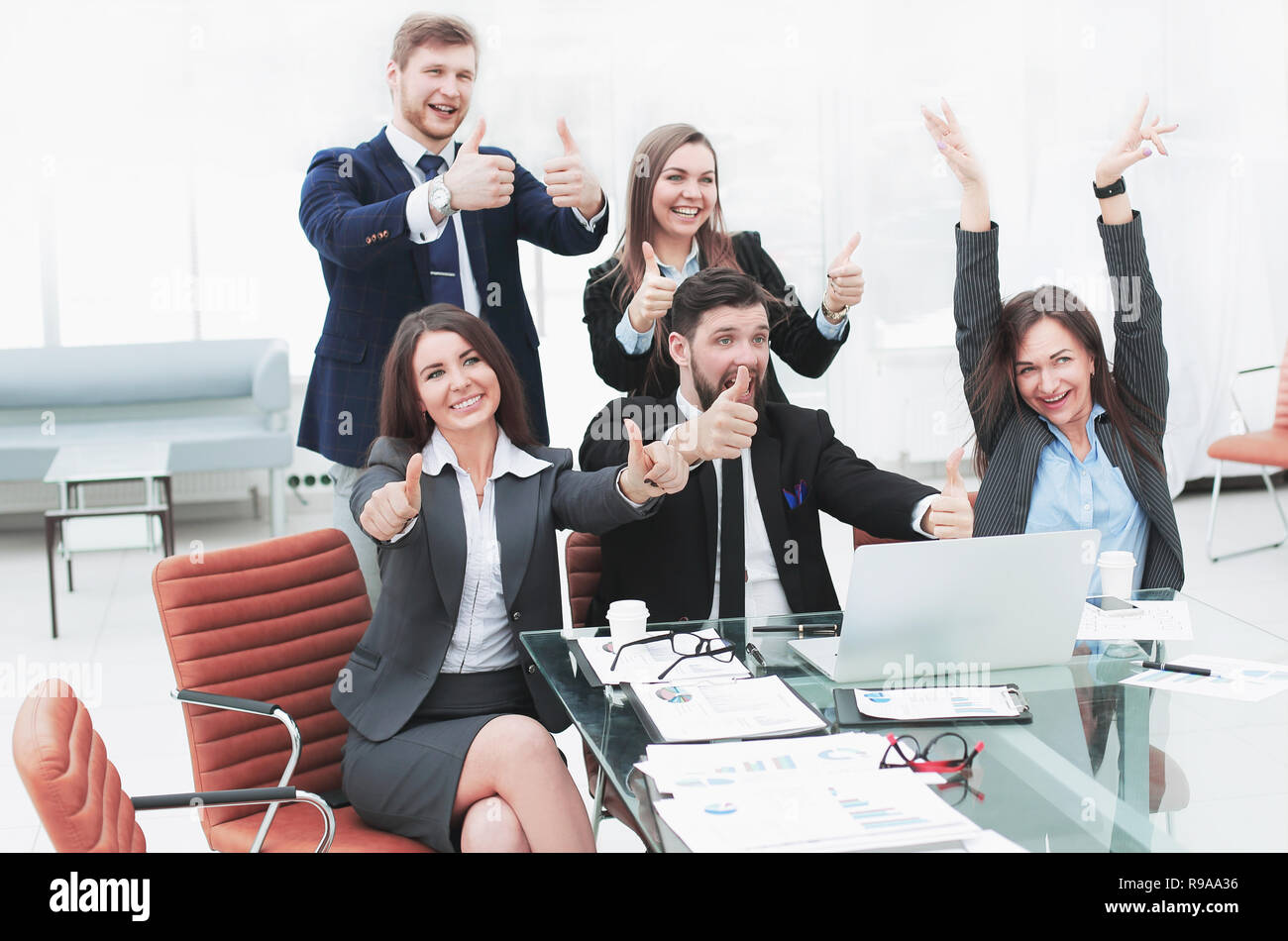 business team with thumbs up and vote for a decision near the desktop ...